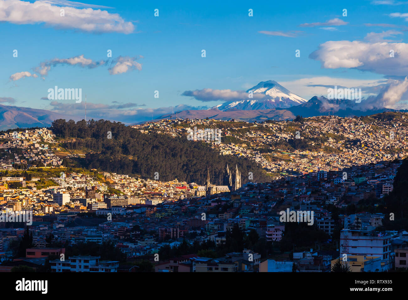 Quito at sunset and the Cotopaxi in the background Stock Photo - Alamy