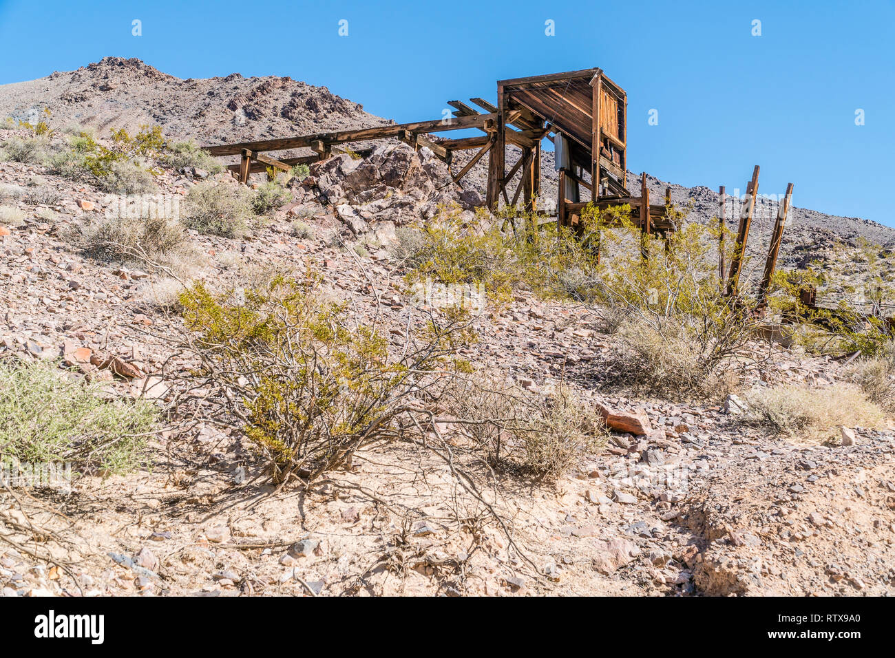 A tall, wooden mining structure at the Inyo Mine in Death Valley ...