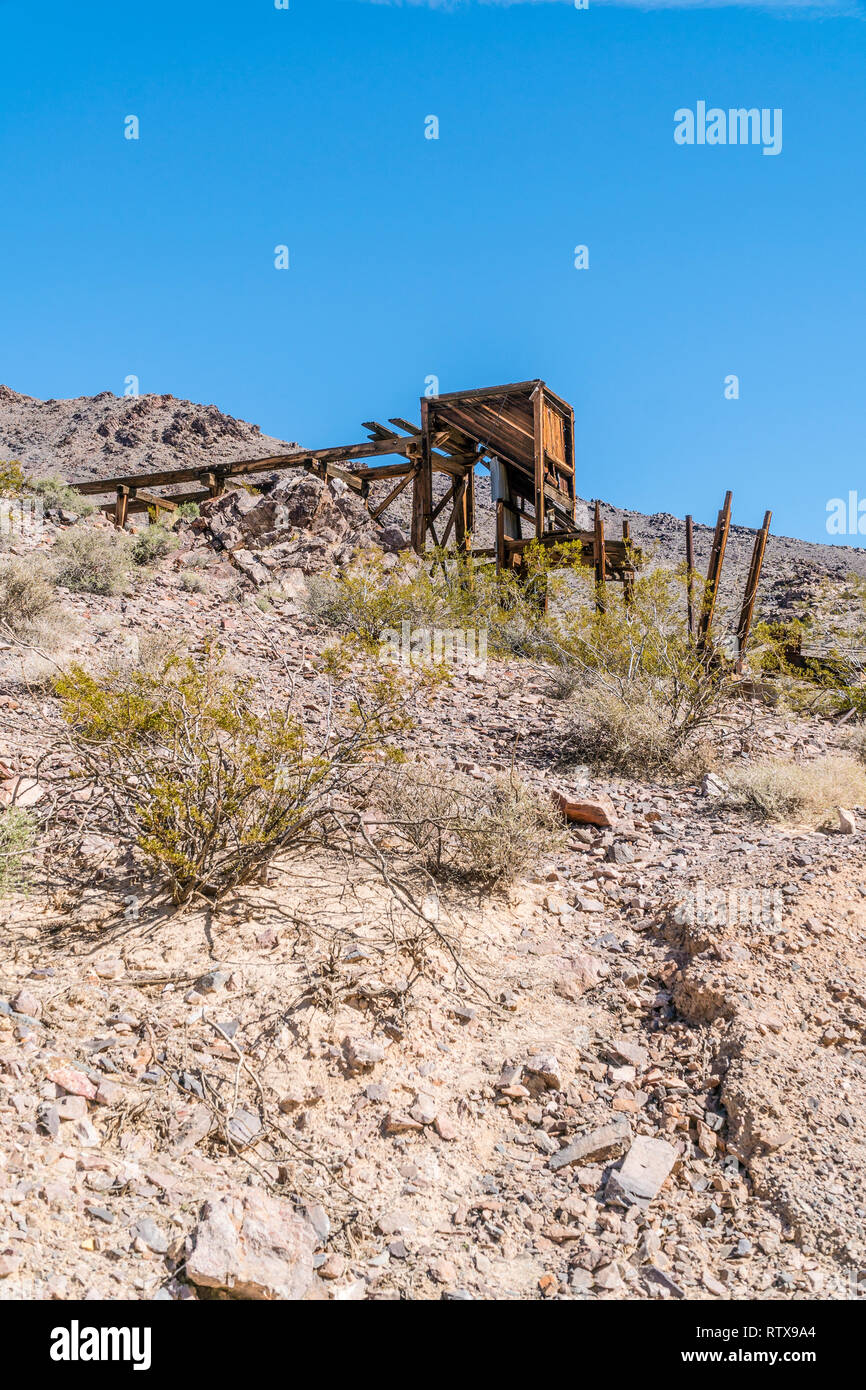 A tall, wooden mining structure at the Inyo Mine in Death Valley ...