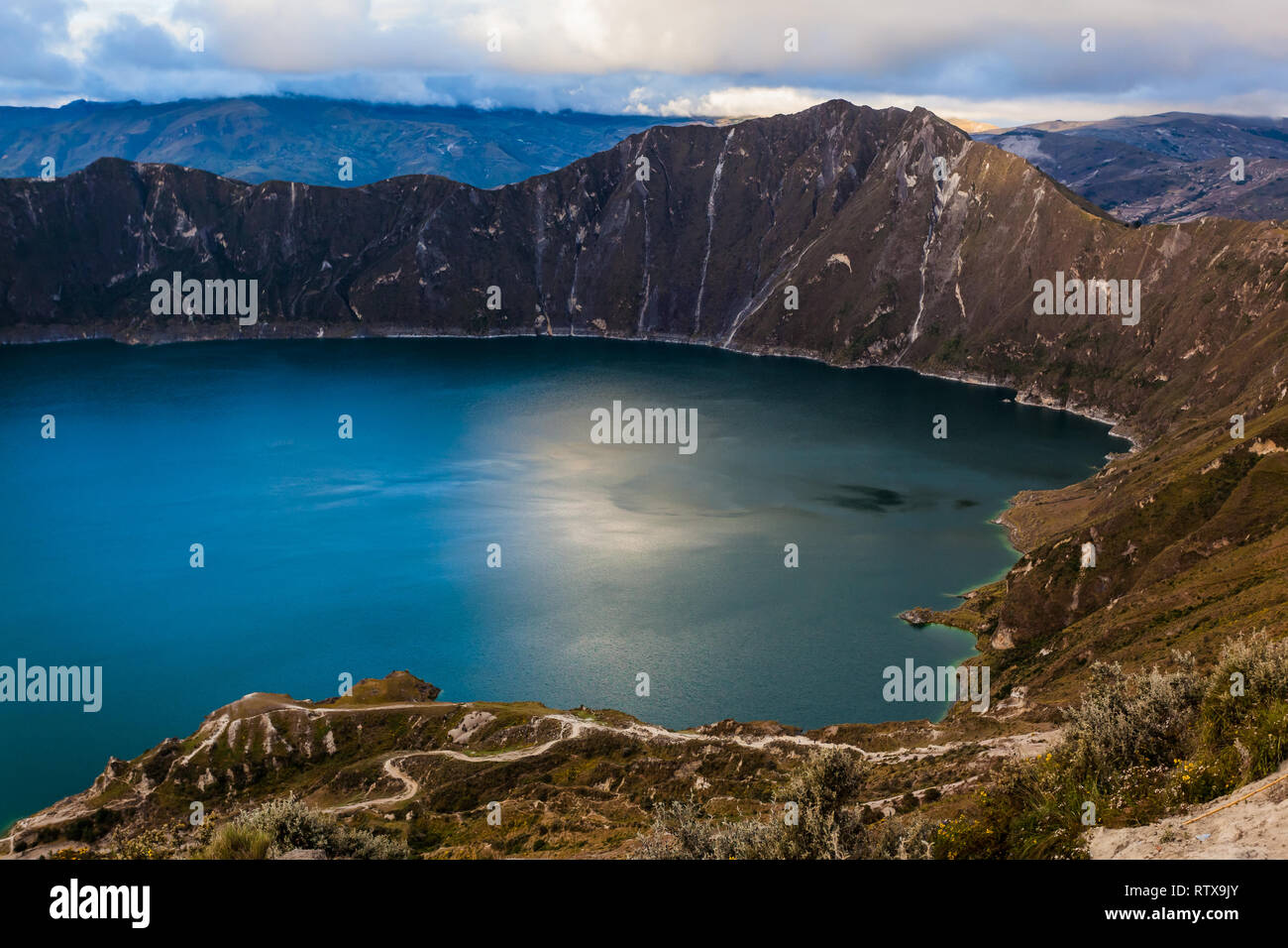 lagoon of the Quilotoa volcano at sunset, with green tones for the ...