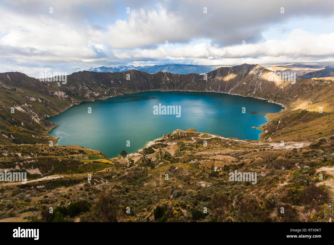 Quilotoa volcano lagoon at sunset, with green tones for the minerals of ...