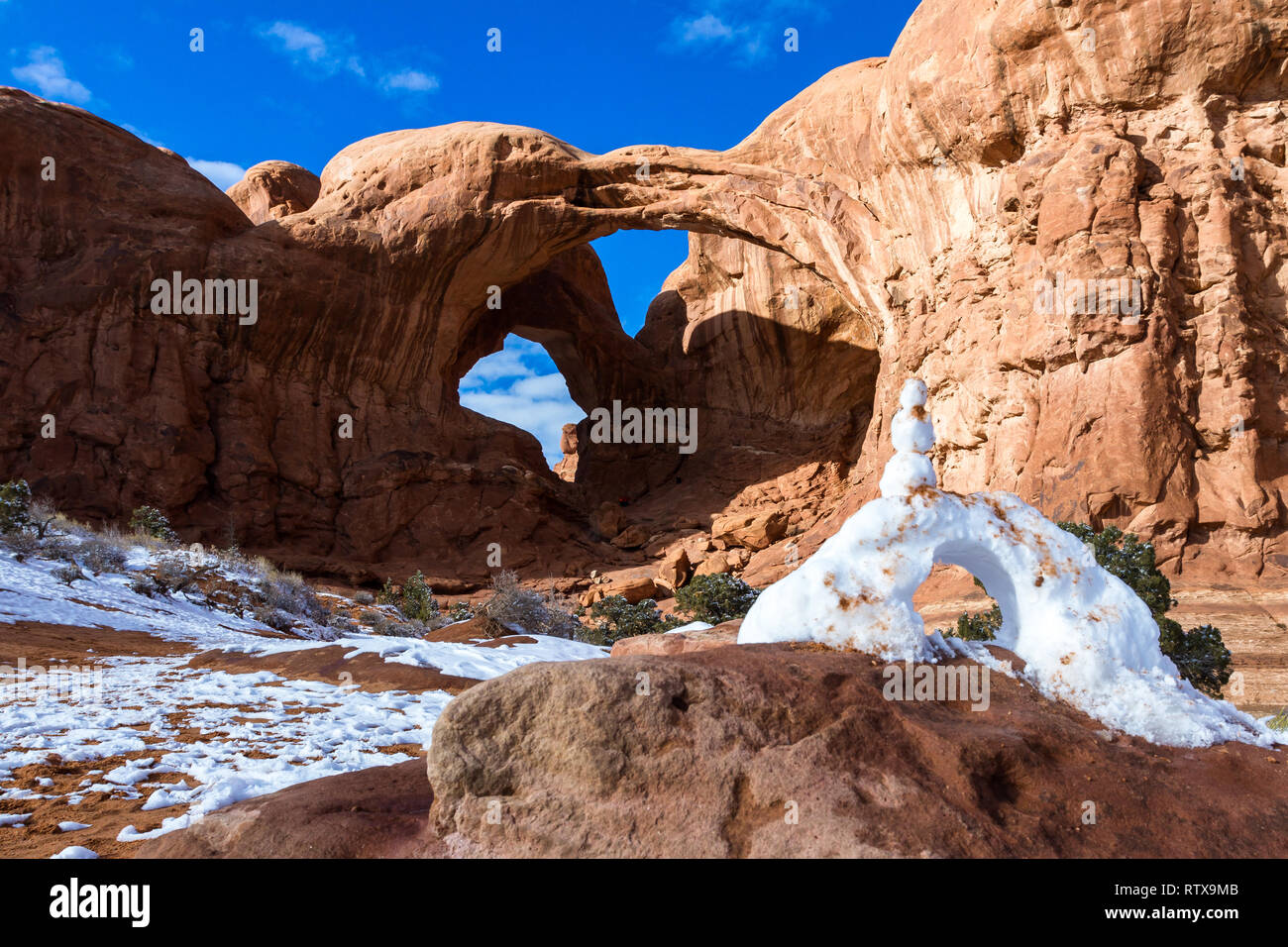 Snow arch in front of double arch as a winter fun concept Stock Photo ...