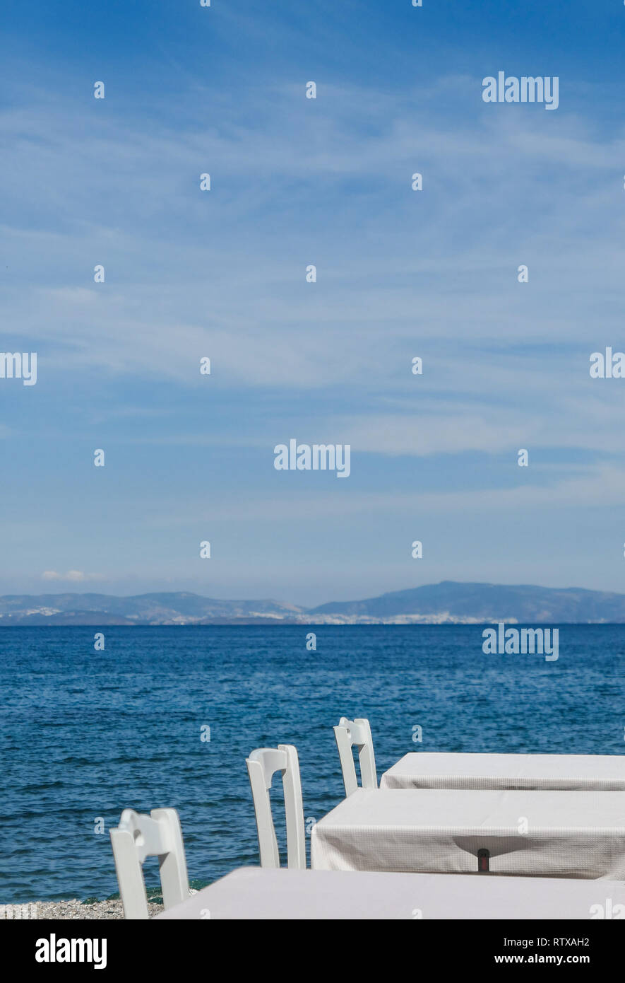 White restaurant tables on the beach in summer - travel, vacation and ...