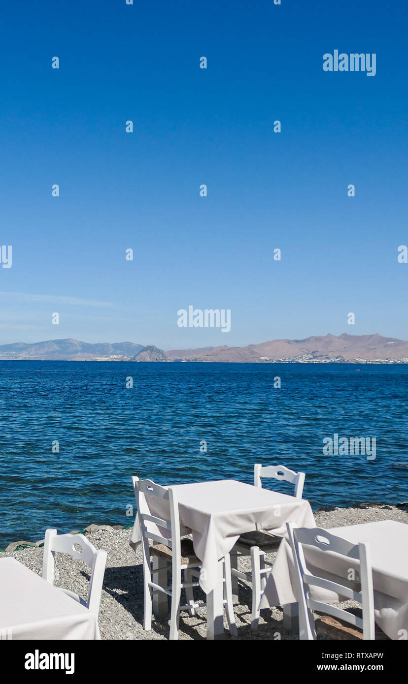 White restaurant tables on the beach in summer - travel, vacation and ...