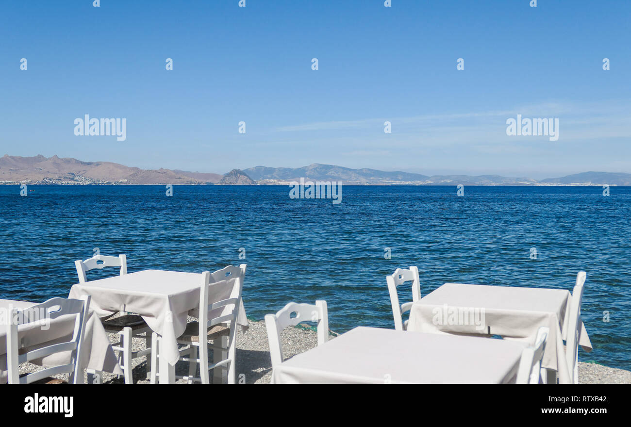White restaurant tables on the beach in summer - travel, vacation and ...