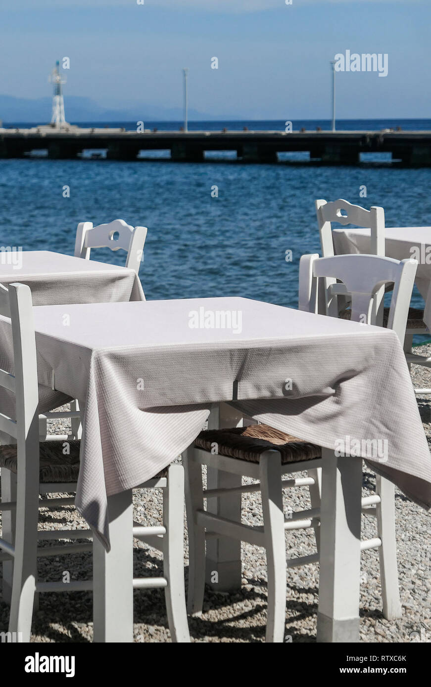 White restaurant tables on the beach in summer - travel, vacation and ...