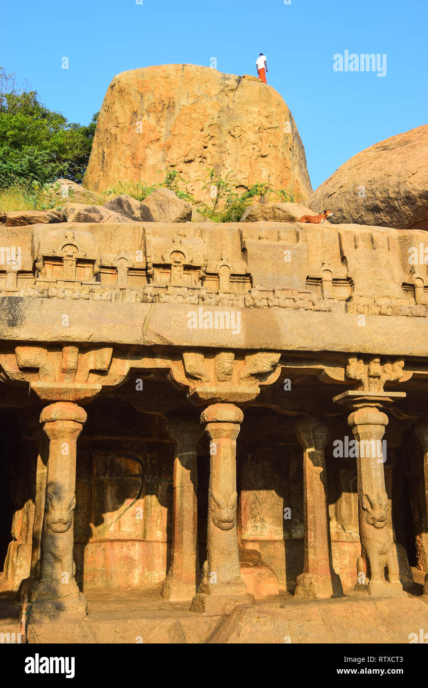 Indian Man on rocks above Ganesha Ratha stone temple, Mamallapuram ...