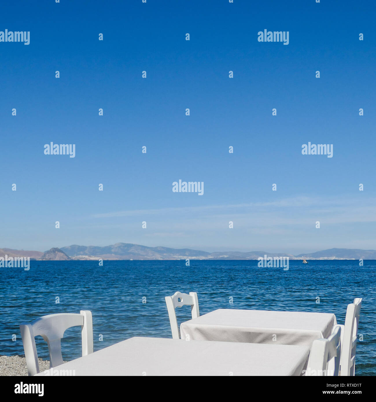 White restaurant tables on the beach in summer - travel, vacation and ...