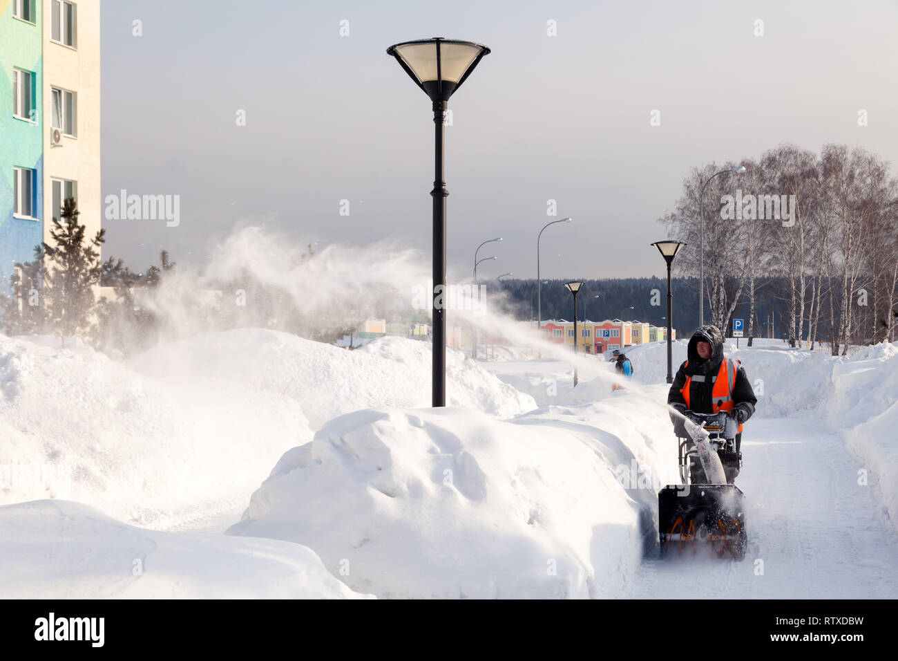 Russia Kemerovo 2019-02-22 Janitor in uniform orange vest cleans ...