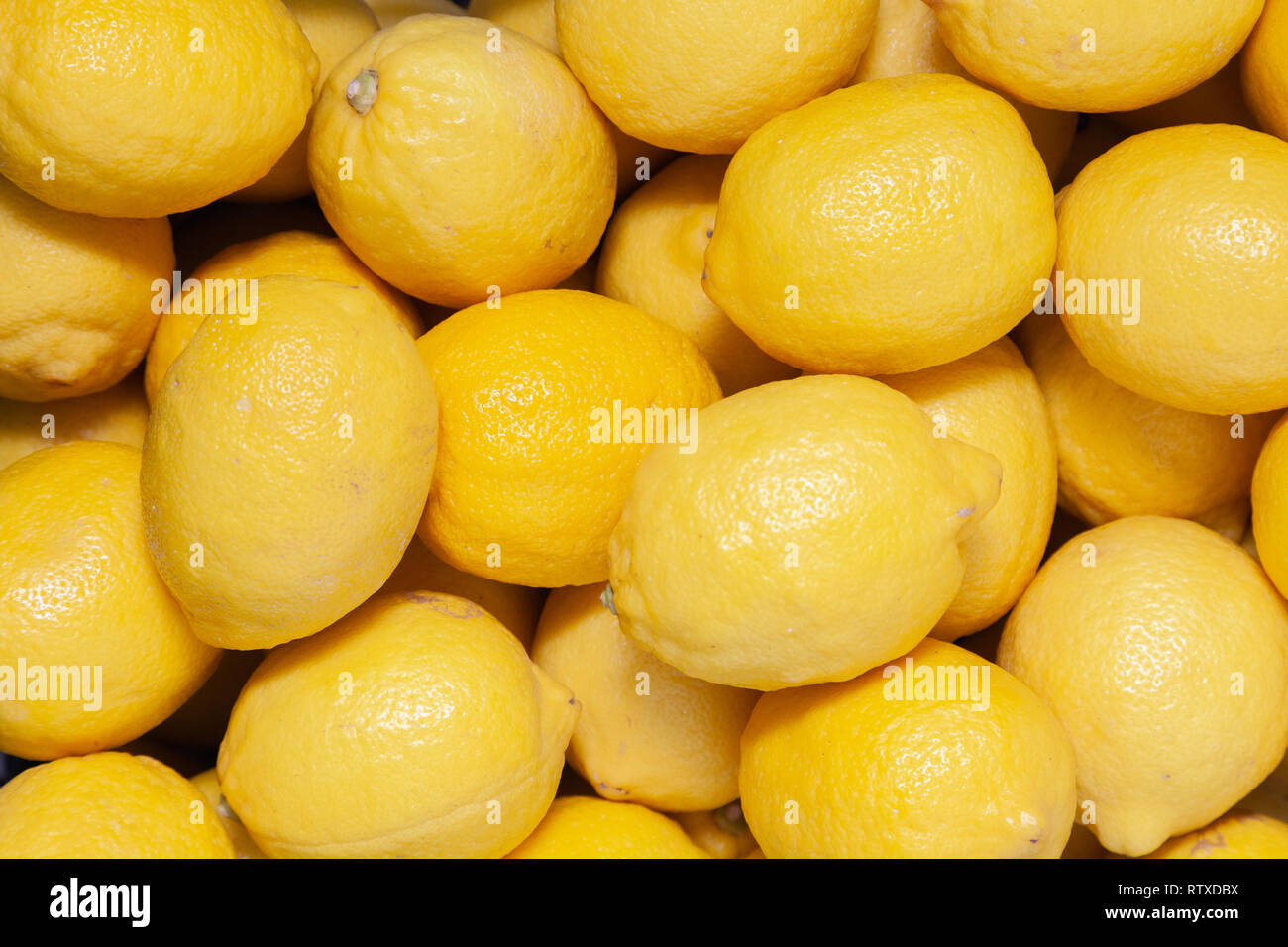 Closeup pile of fresh yellow lemons on the counter at the farmers ...
