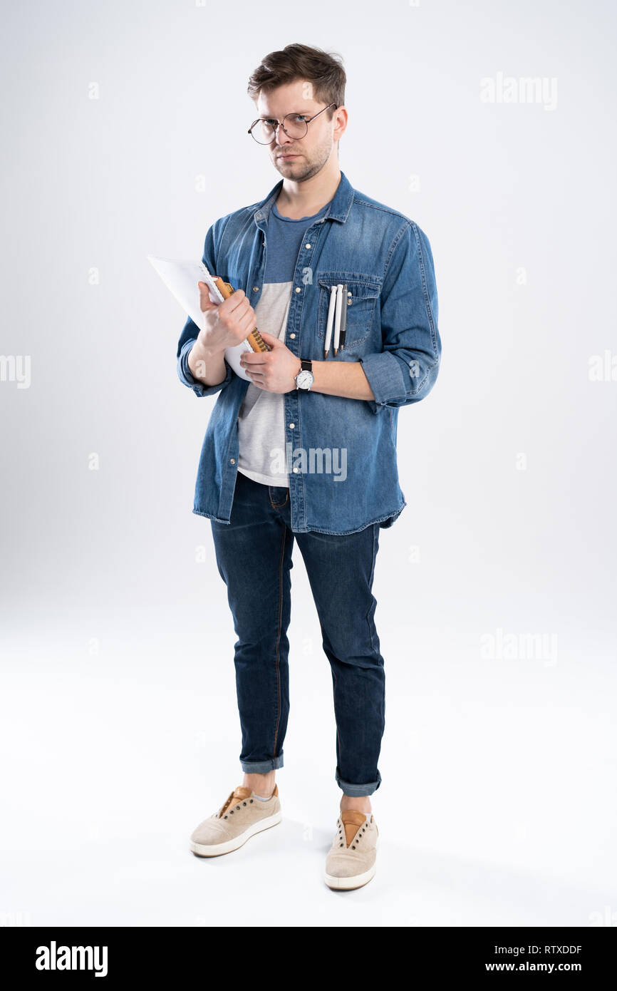 Happy young student standing full length with books and notes isolated ...