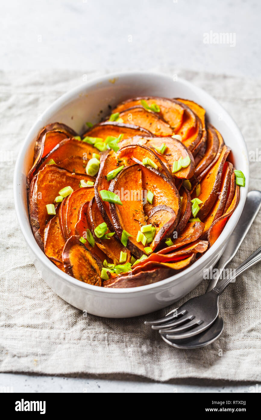 Baked sliced yam with green onions in white dish Stock Photo - Alamy
