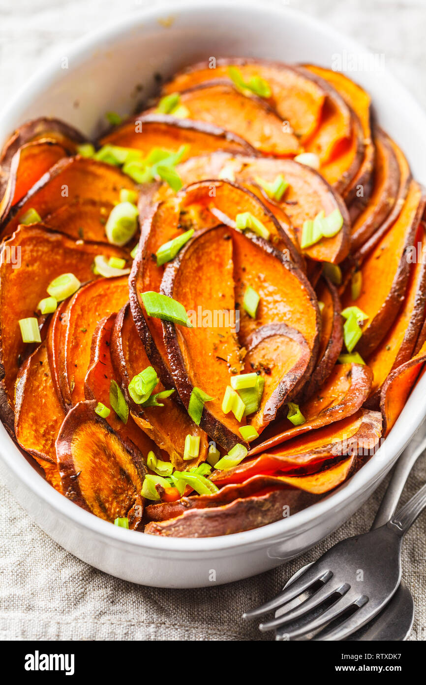 Baked sliced yam with green onions in white dish Stock Photo - Alamy