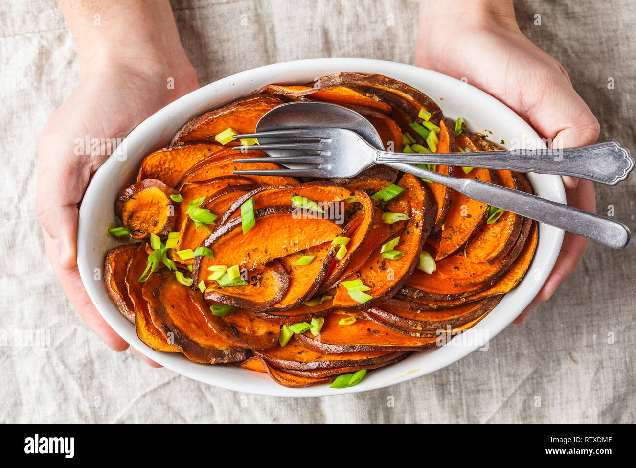Baked sliced yam with green onions in white dish Stock Photo - Alamy