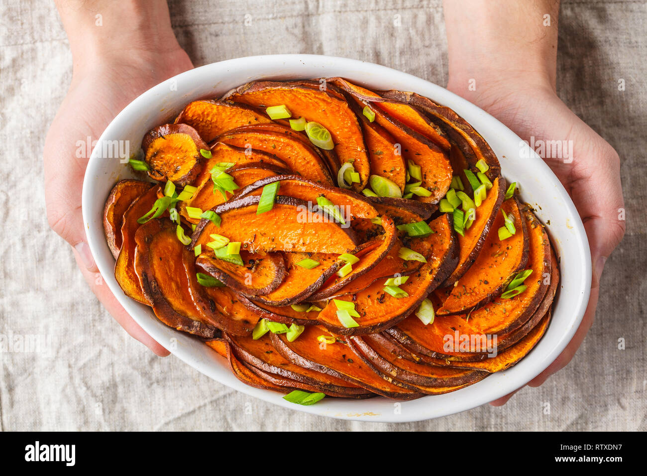 Baked sliced yam with green onions in white dish Stock Photo - Alamy