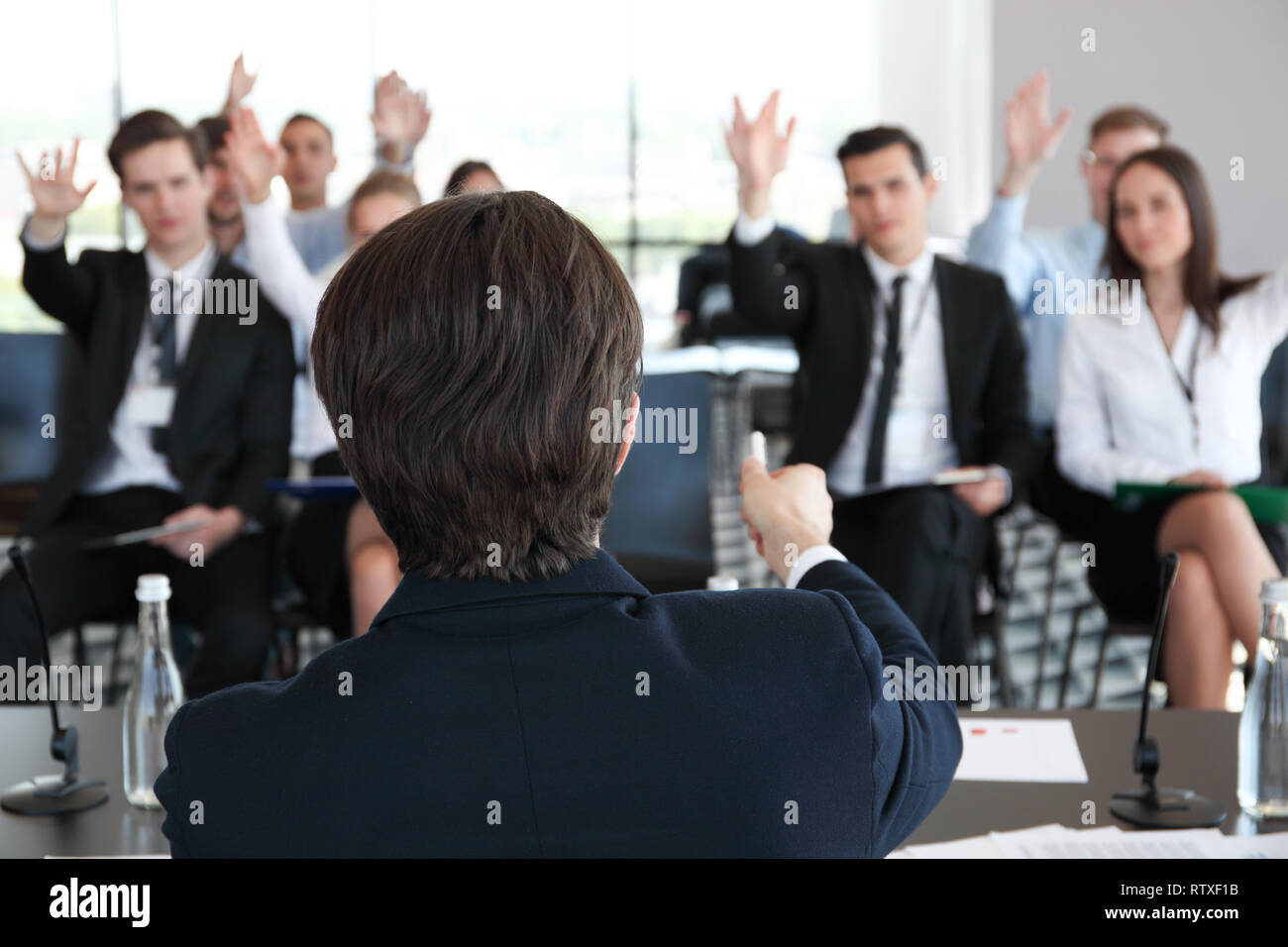 Speaker at business conference and audience answering questions Stock ...