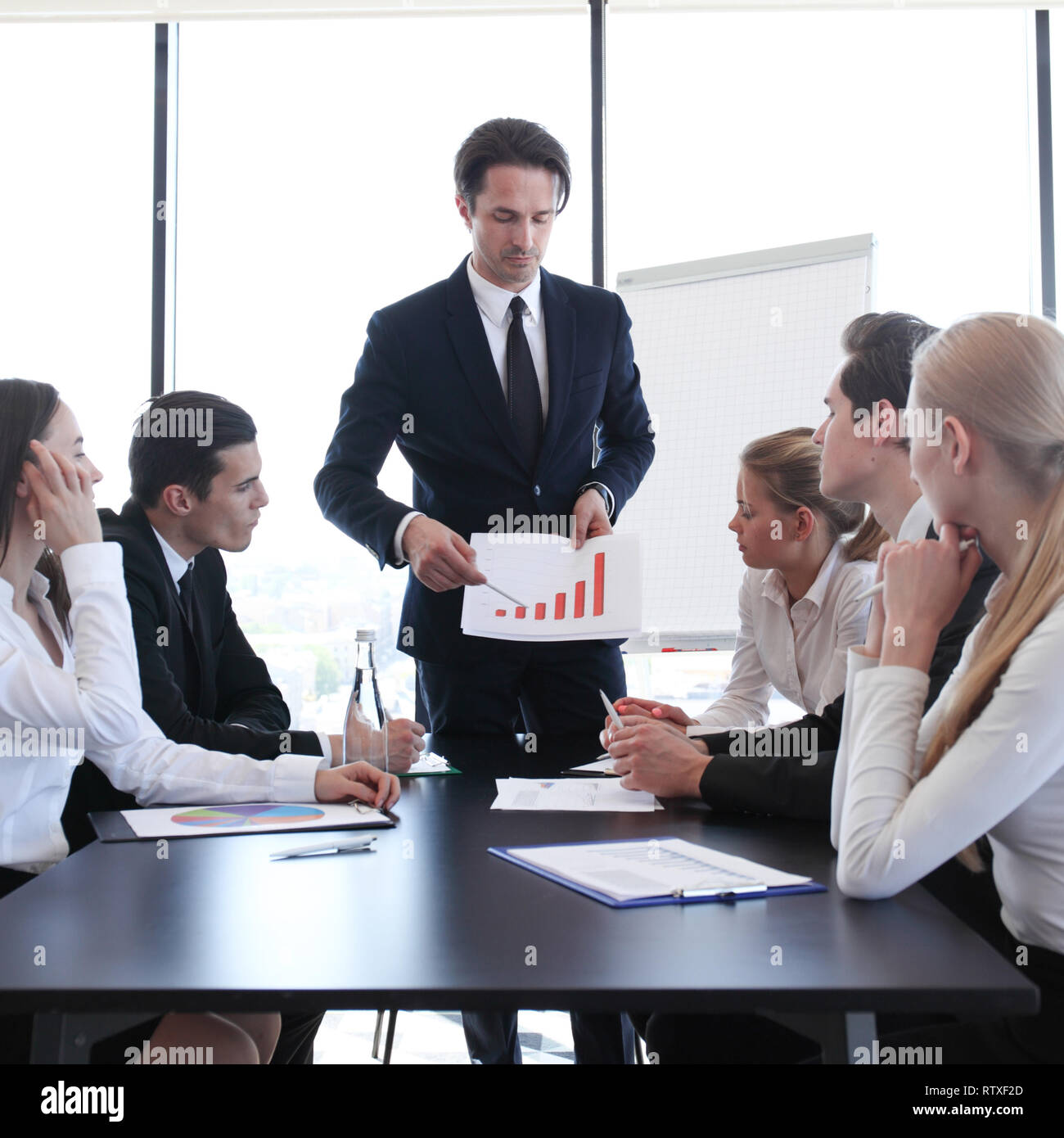 Business man showing financial statistics graph at meeting Stock Photo ...
