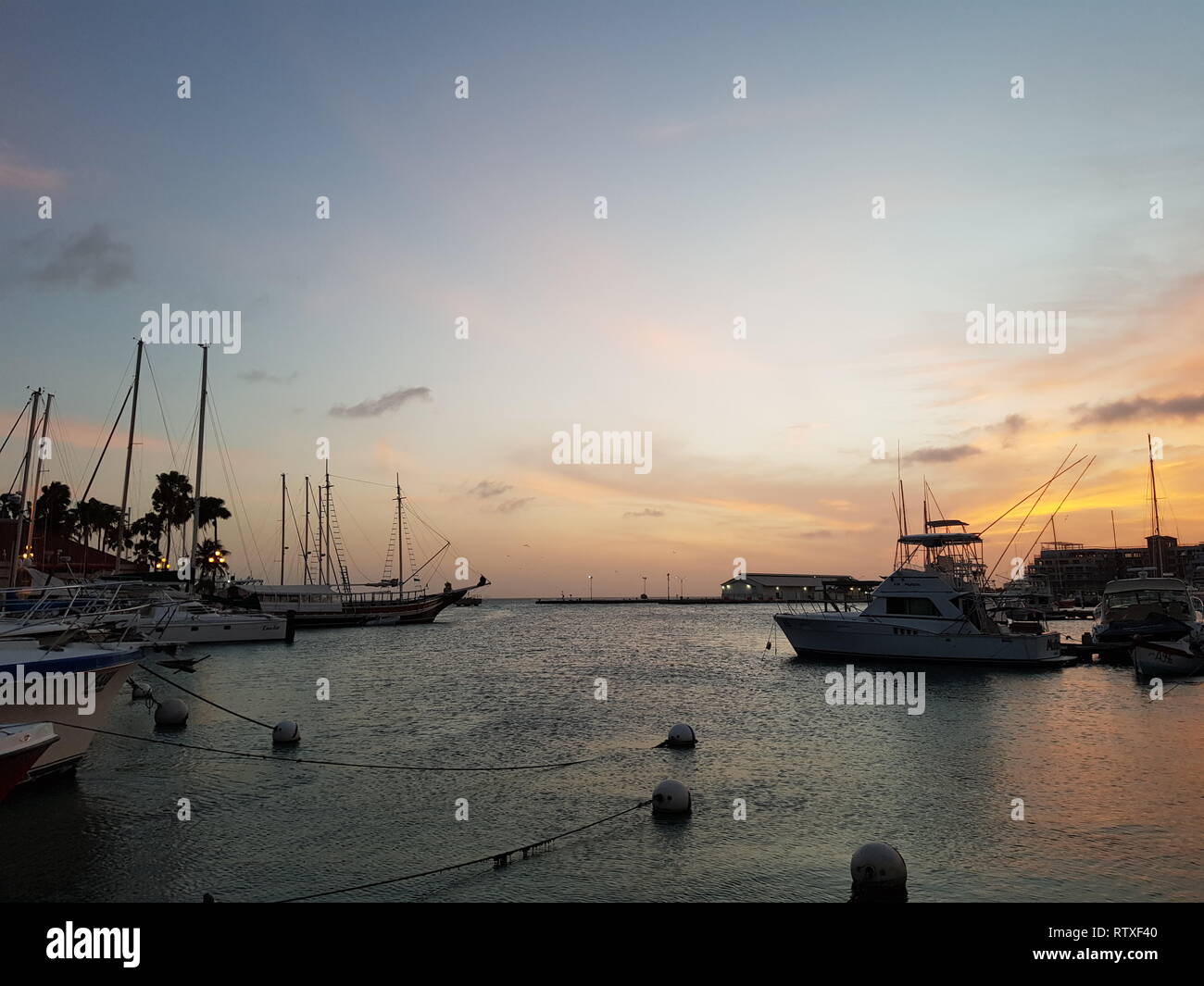 Romantic sunset in the harbour of Aruba Stock Photo - Alamy