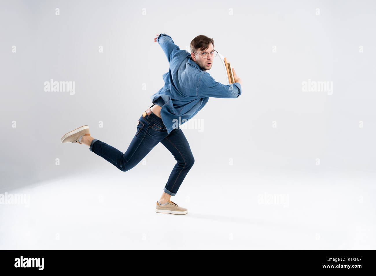 Full length portrait of a happy excited man jumping and looking at ...