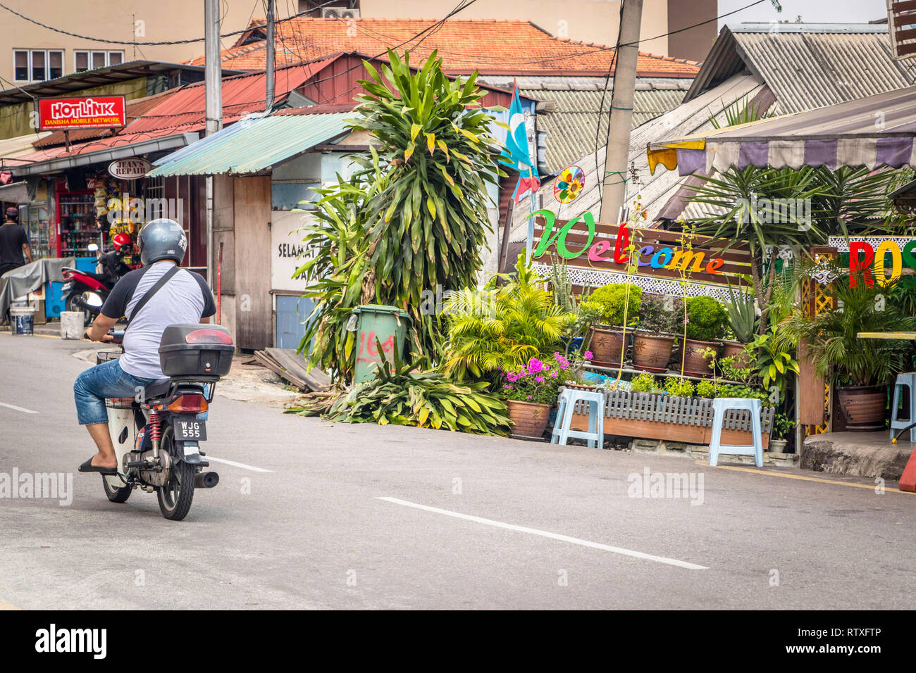 man riding moped motorbike in street in Kuala Lumpur Malaysia Stock ...