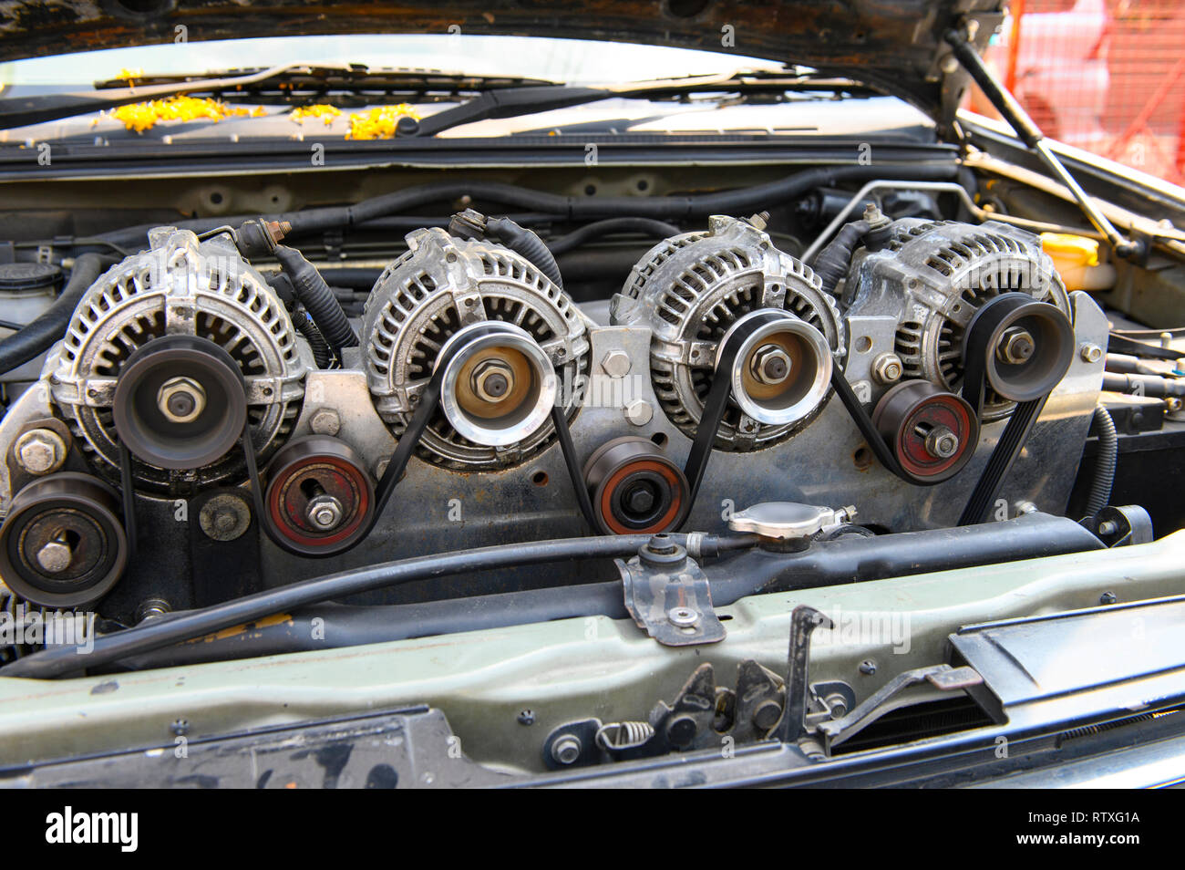 Four alternator for the car attached on engine Stock Photo - Alamy
