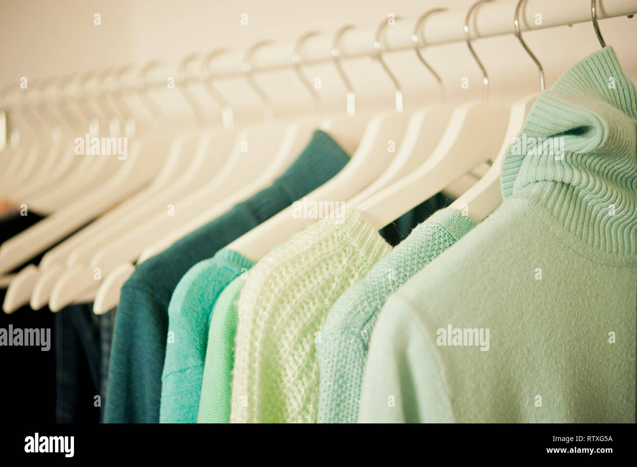 rack with hanging sweaters Stock Photo - Alamy