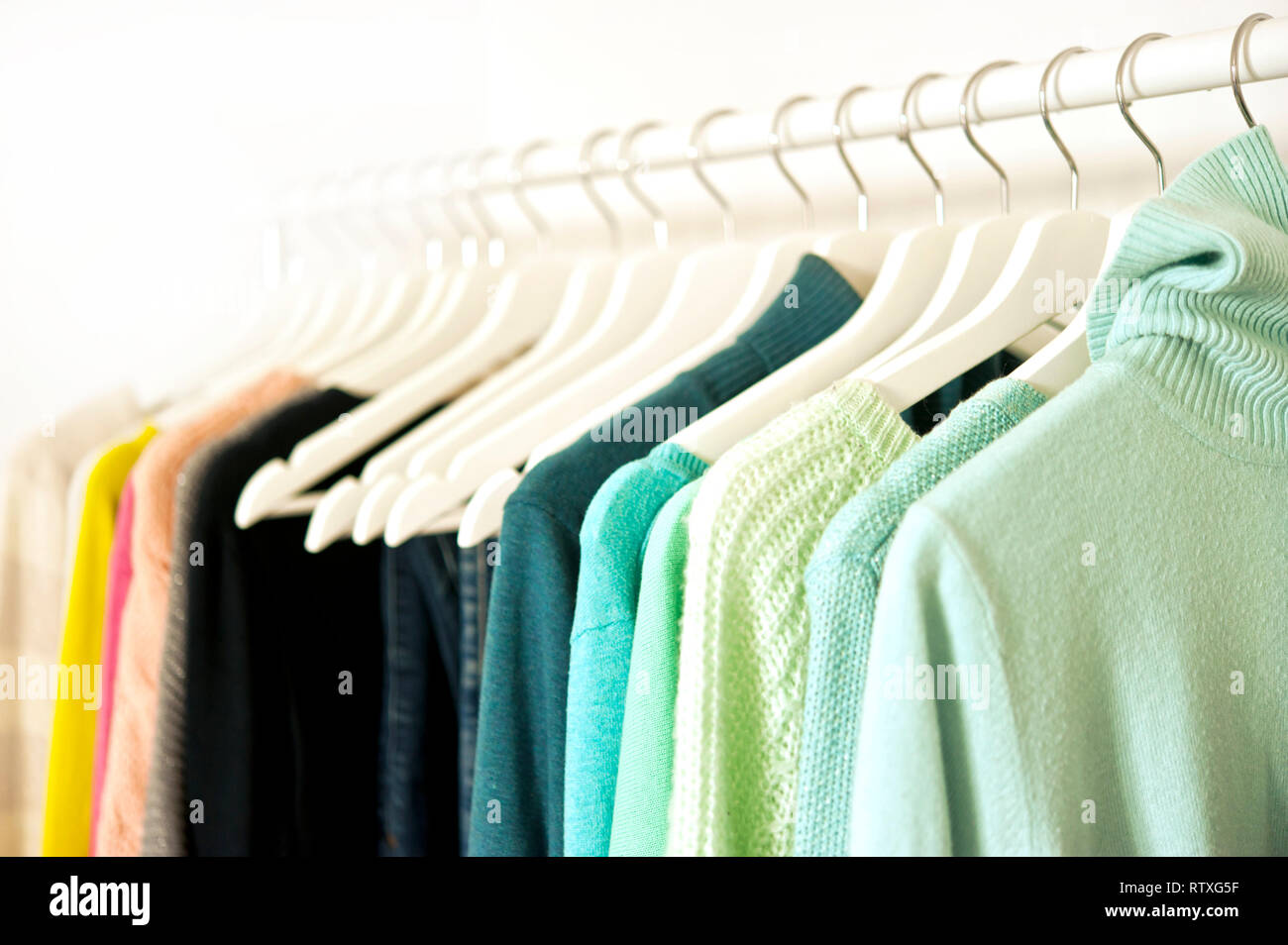 rack with hanging sweaters Stock Photo - Alamy