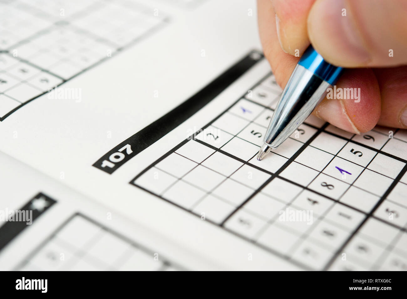hand of a man solving a Sudoku puzzle Stock Photo - Alamy