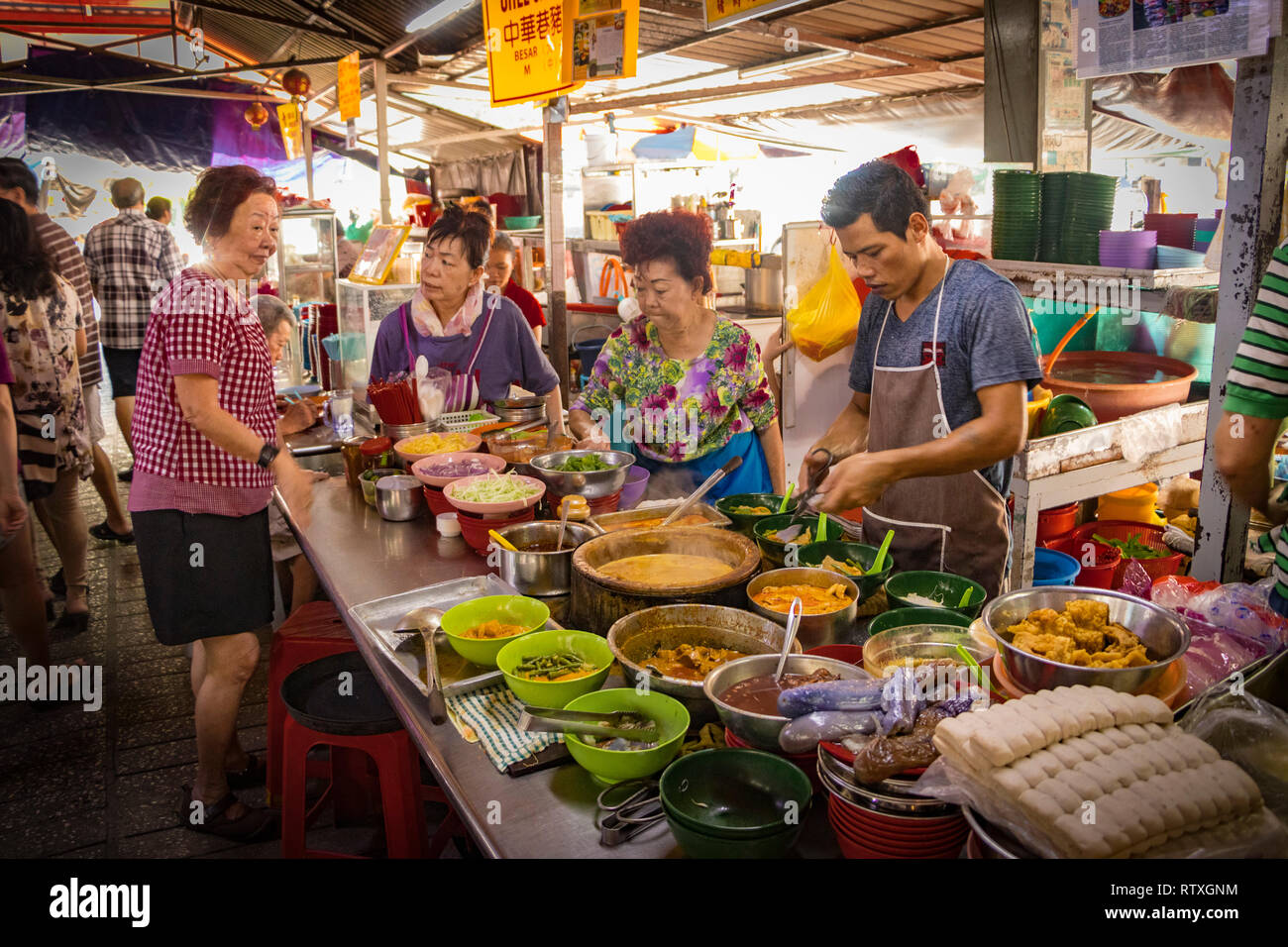 preparing food on market stall in Chinatown Kuala Lumpur, Malaysia ...