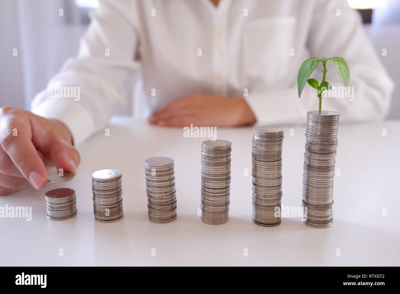 growing plant on coin stack row of coins for finance and banking ...