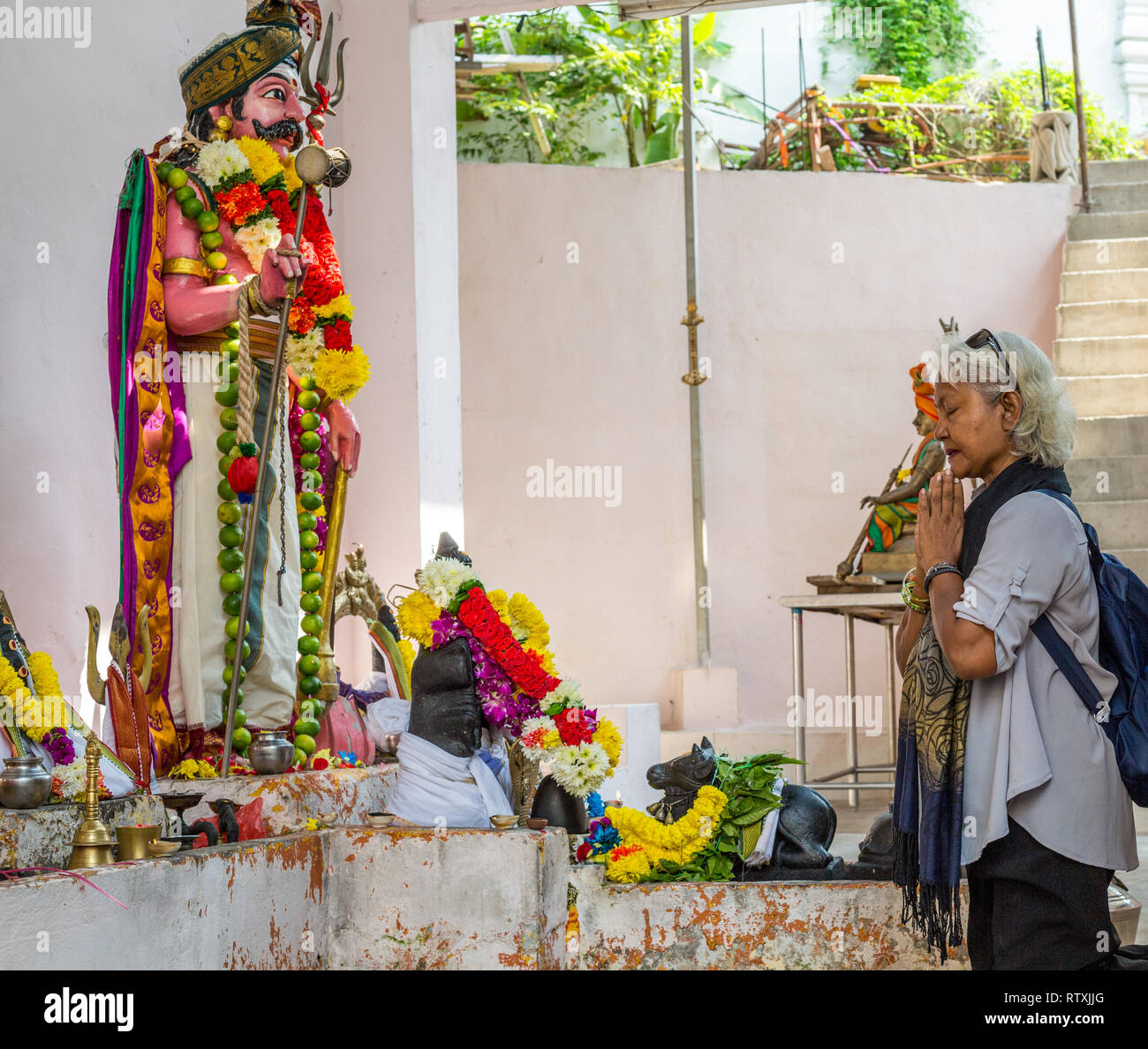 Worshiper Praying in front of Hindu Deity, Hindu Sri Maha Muneswarar ...