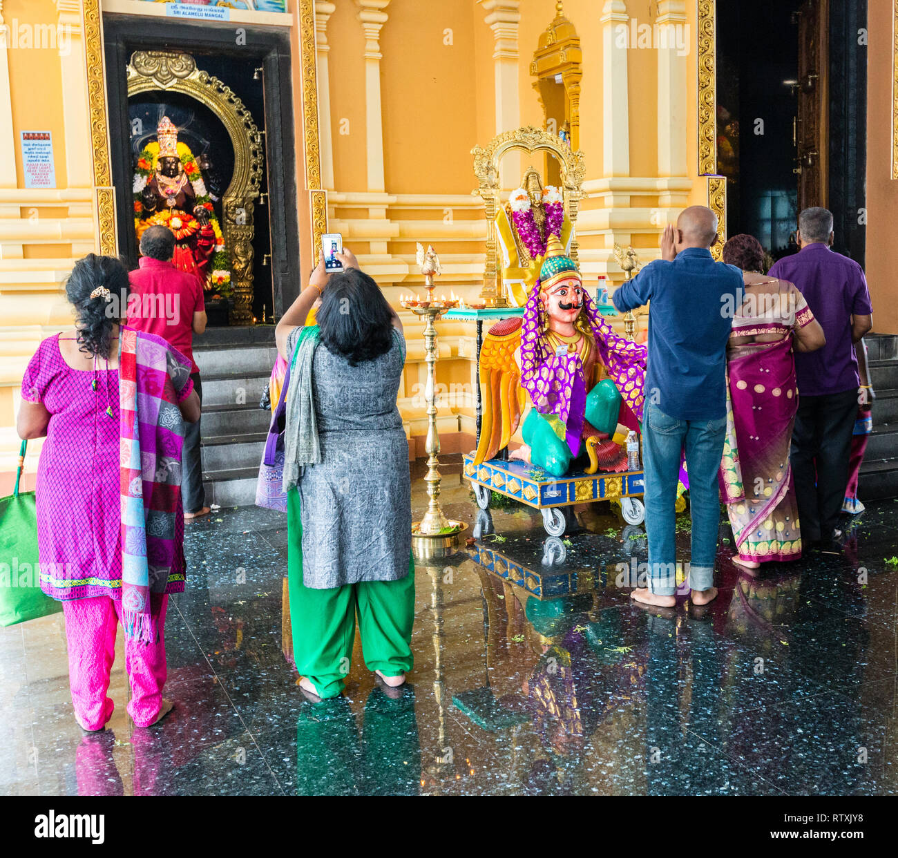 Worshipers Praying, Taking Photos, in Kuil Sri Krishna Hindu Temple ...