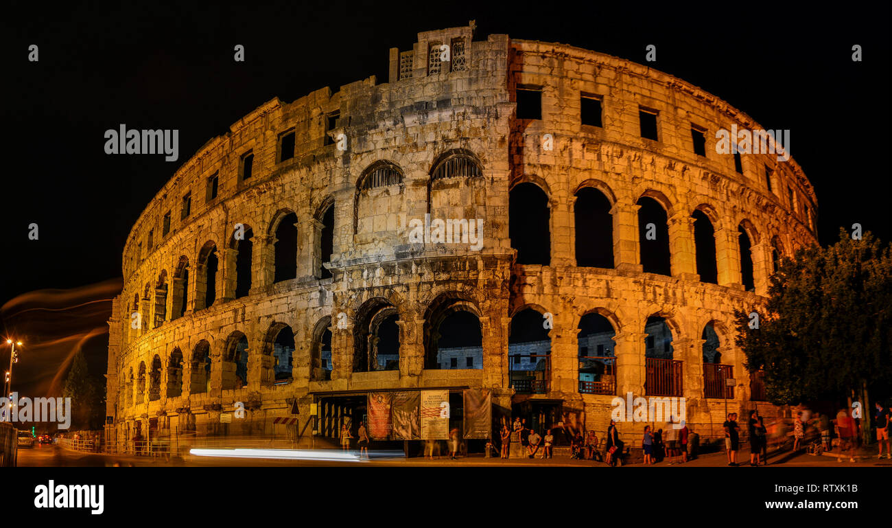 The Pula Arena at night. It is illuminated so that it becomes ...
