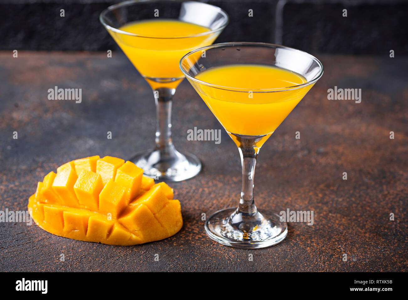 Tropical cocktail with mango on dark background Stock Photo - Alamy