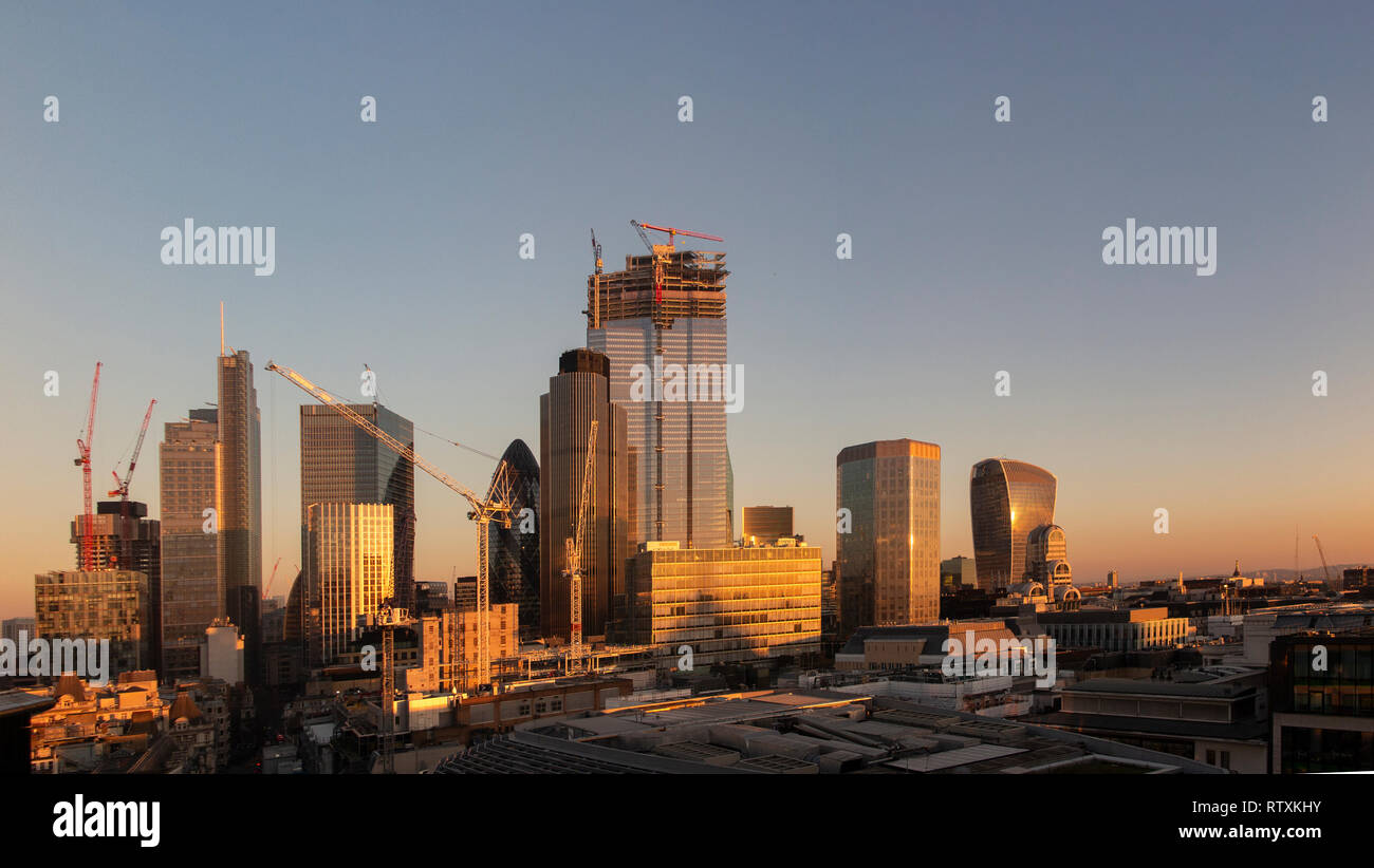 A dramatic City of London skyline with the high rise buildings bathed ...