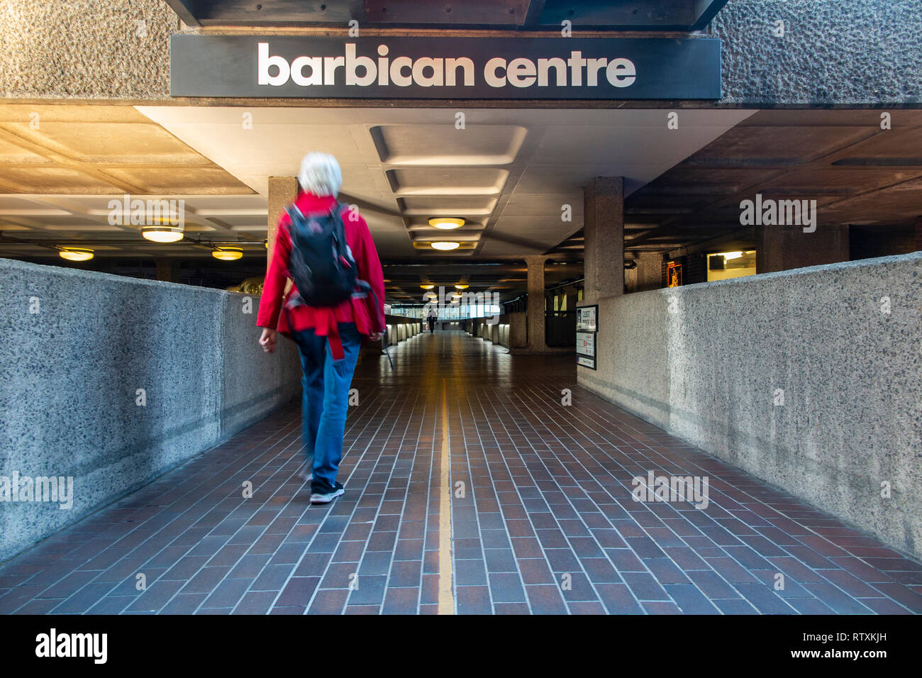 Walking through the interior walkways of the Barbican centre Stock ...