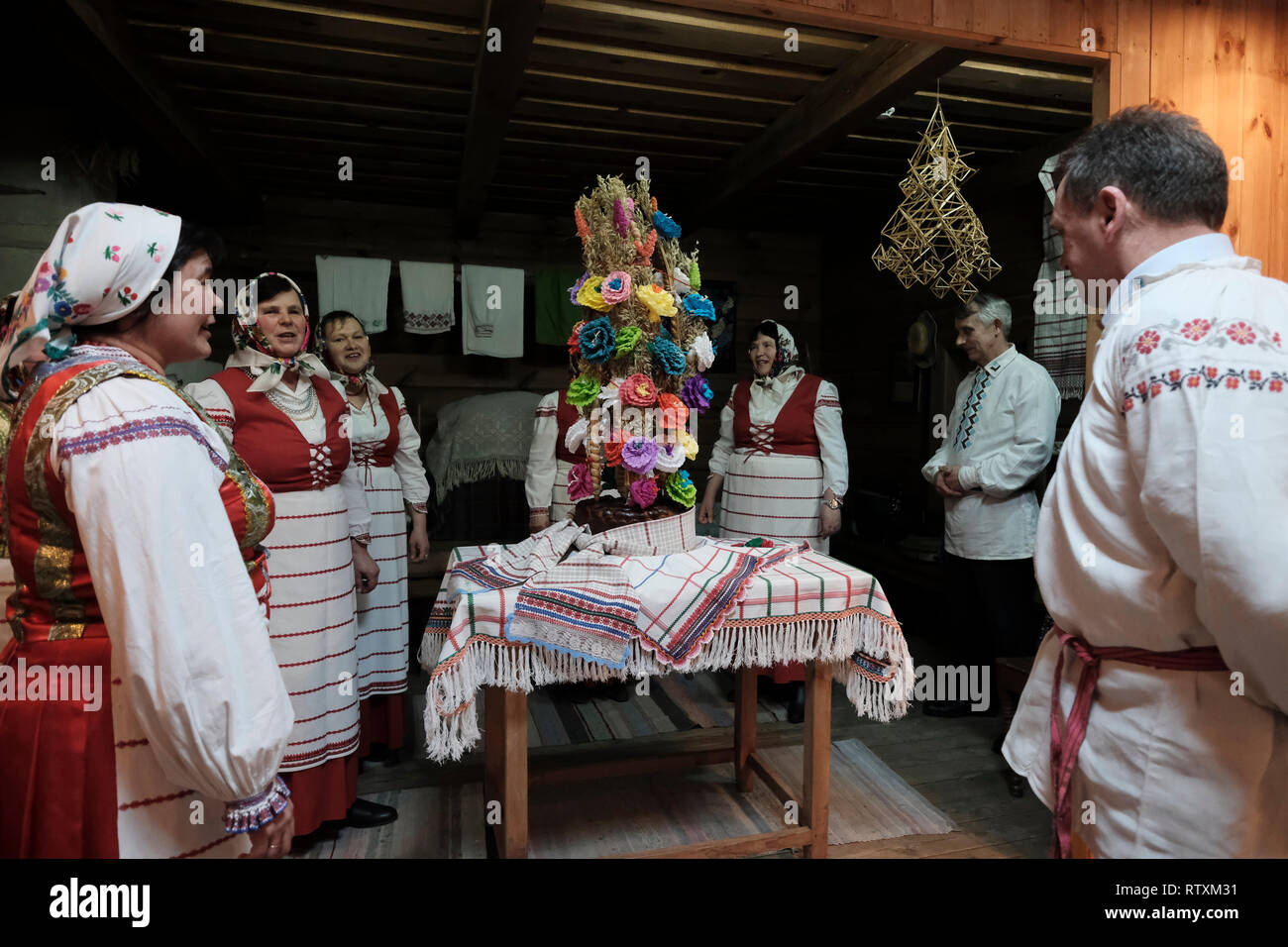 Belarusian people in traditional garment singing folk songs around a ...