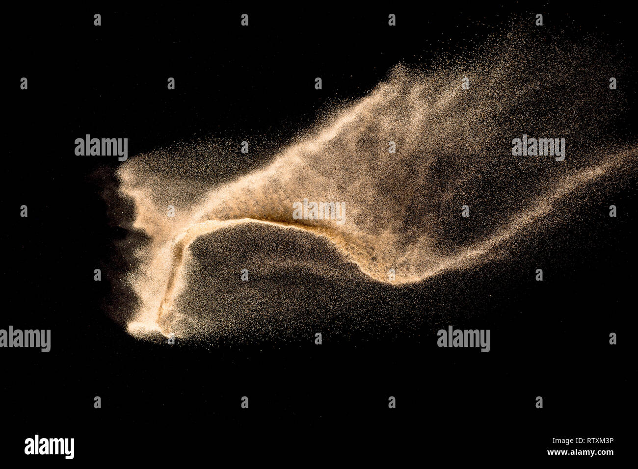 Dry river sand explosion. Brown color sand splash against black ...