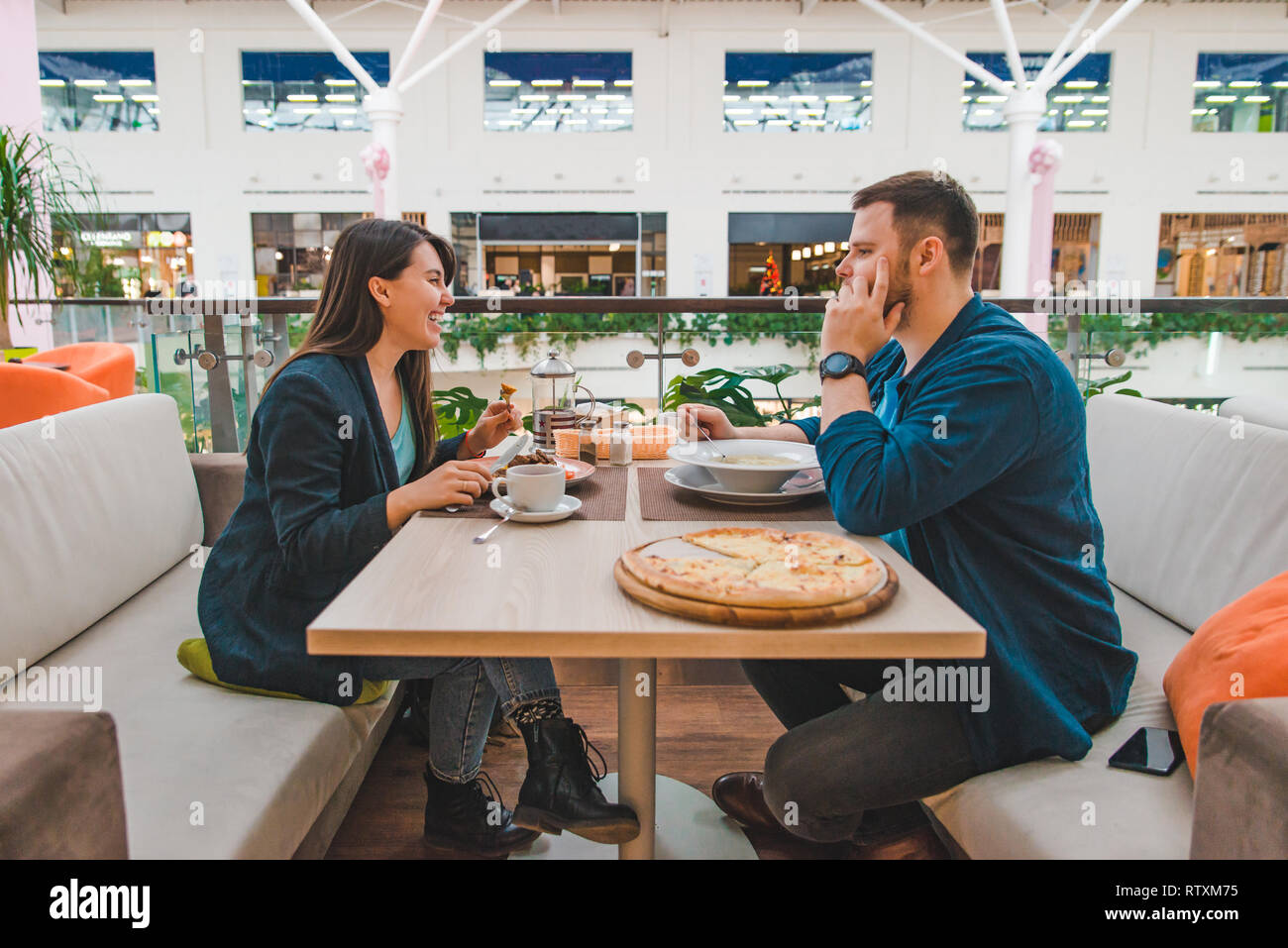 couple having lunch in mall cafe together. date talking. relationship ...