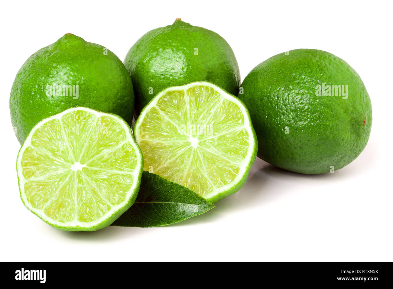 three limes with halves and leaf isolated on white background Stock ...