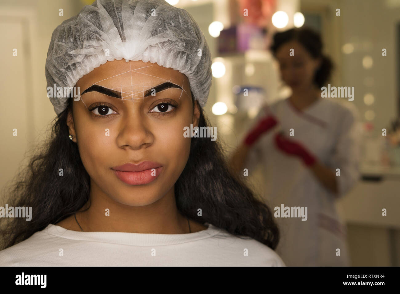 Eyebrow shape correction procedure. Beauty treatment at spa salon ...