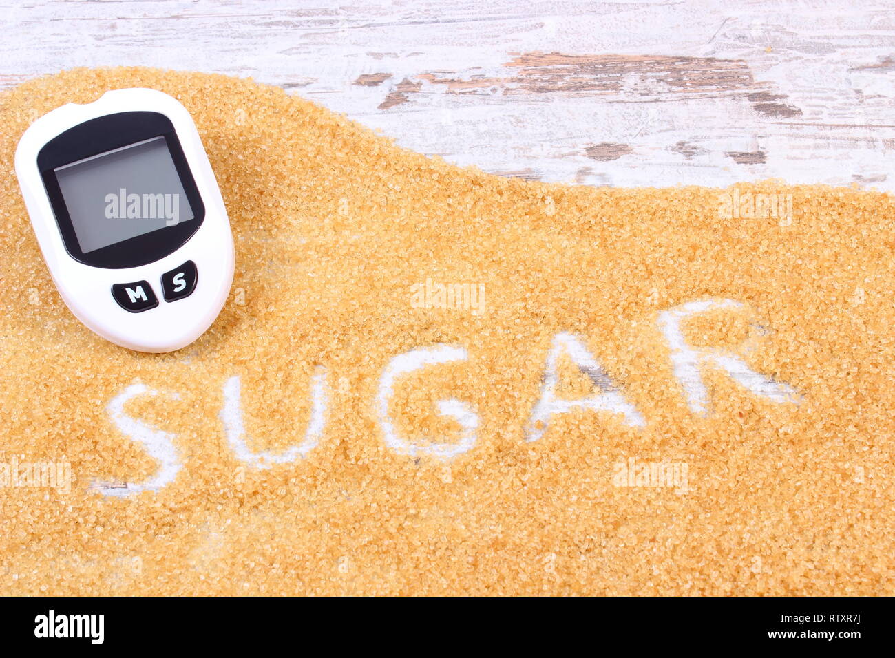 Glucose meter and natural brown cane sugar, concept of diabetes ...