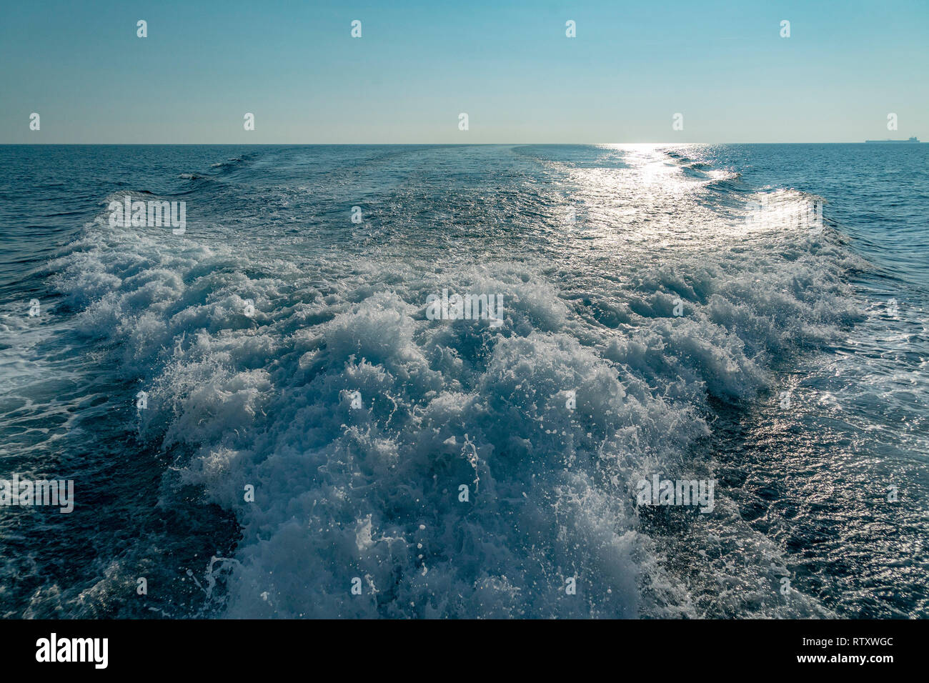 ship wake in pacific ocean at sunset Stock Photo - Alamy