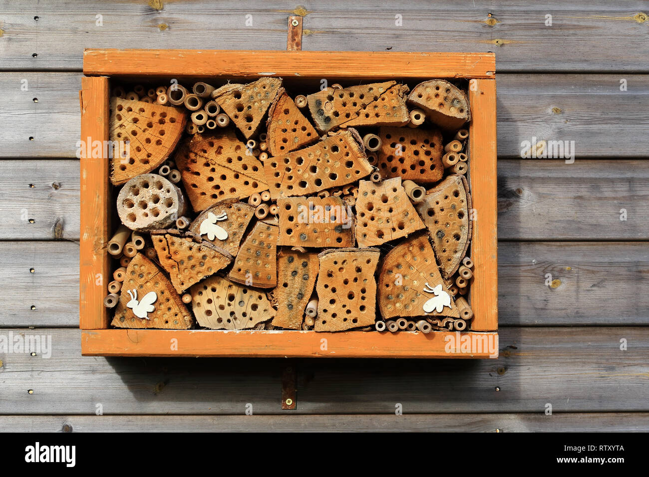 A bug house with various shaped wood peices in Stock Photo - Alamy