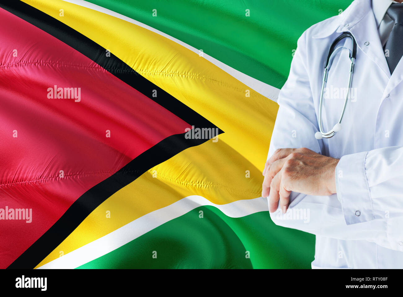 Guyanese Doctor standing with stethoscope on Guyana flag background ...