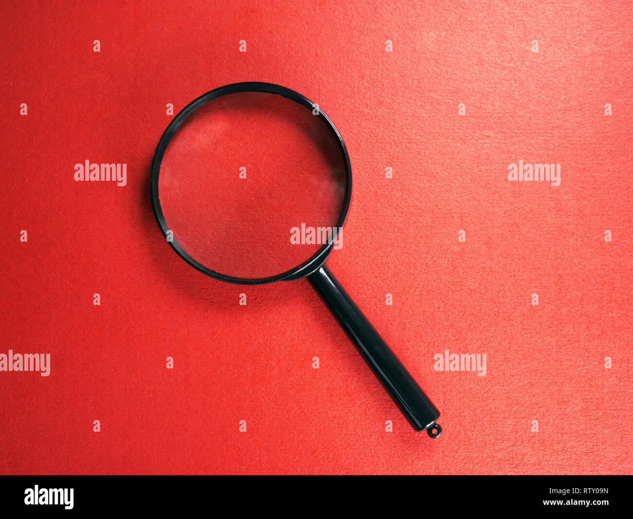 Plastic magnifying glass on a red background, close-up Stock Photo - Alamy