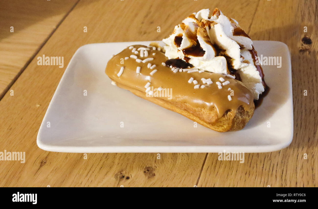 caramel choux pastry on plate with creme Stock Photo - Alamy