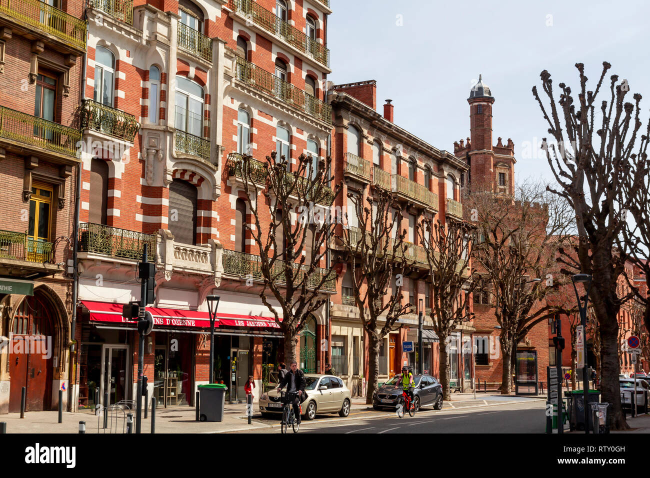 Toulouse street with elegant buildings in brickwork and some stores in ...