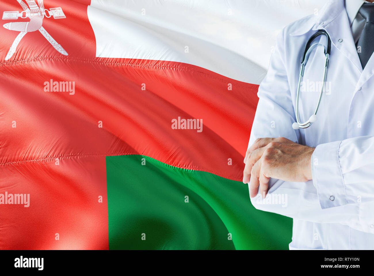 Omani Doctor standing with stethoscope on Oman flag background ...