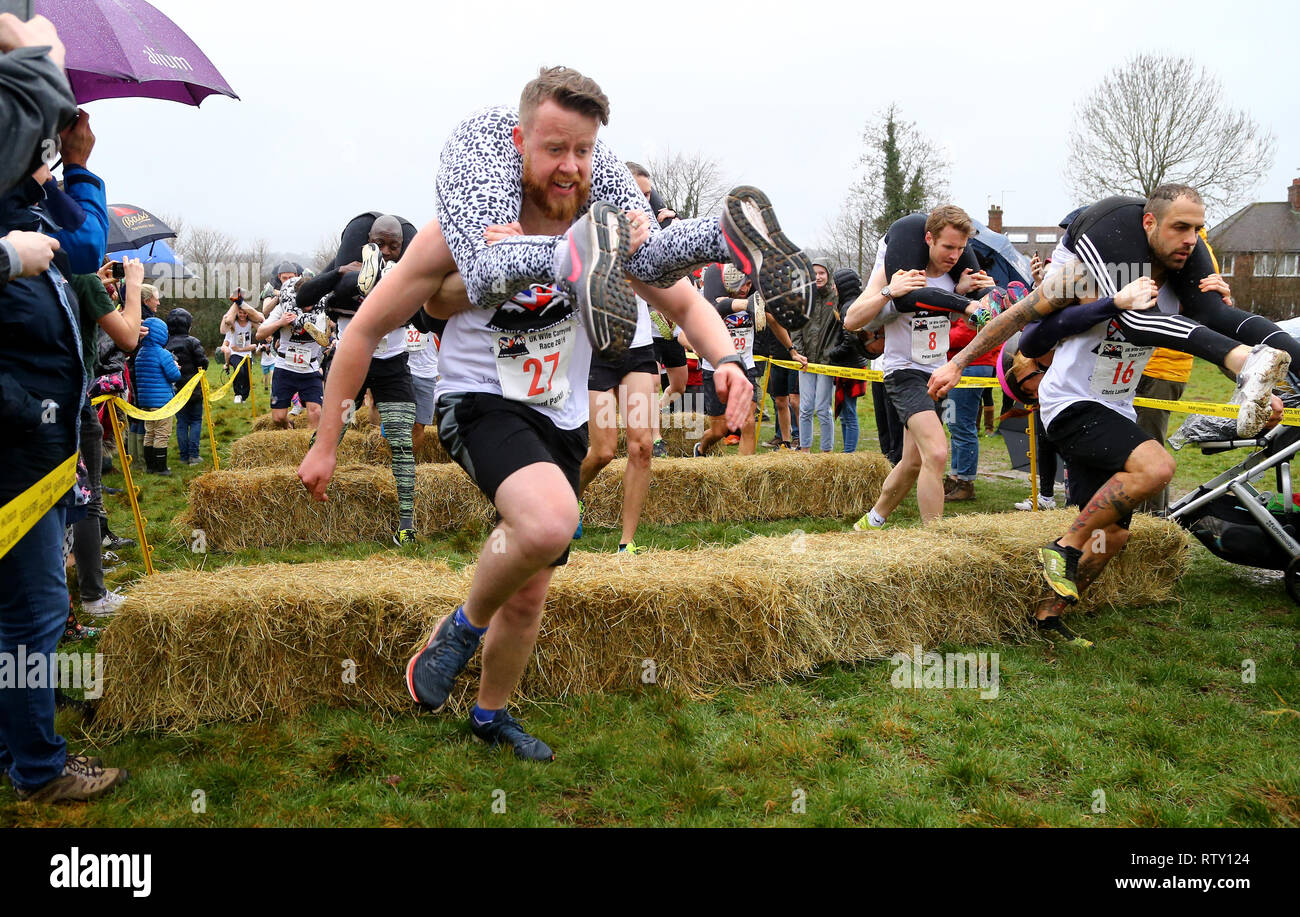 Competitors take part in the annual UK Wife Carrying Race at The Nower ...